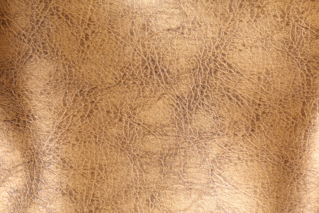 Sklyra Vinyl Upholstery Fabric in Gold